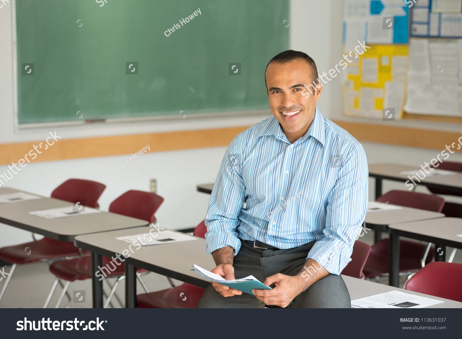 stock-photo-hispanic-male-teacher-in-his-classroom-113631037 | Heritage